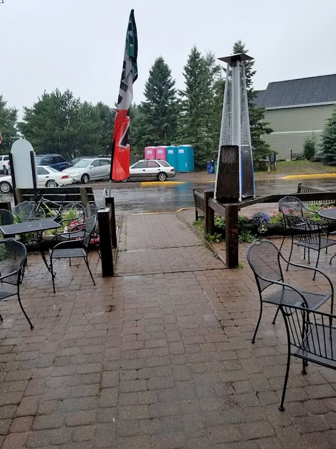 The storefront seating area on a rainy day still has charm, with patio heaters standing ready like loyal soldiers waiting to fight off the chill.