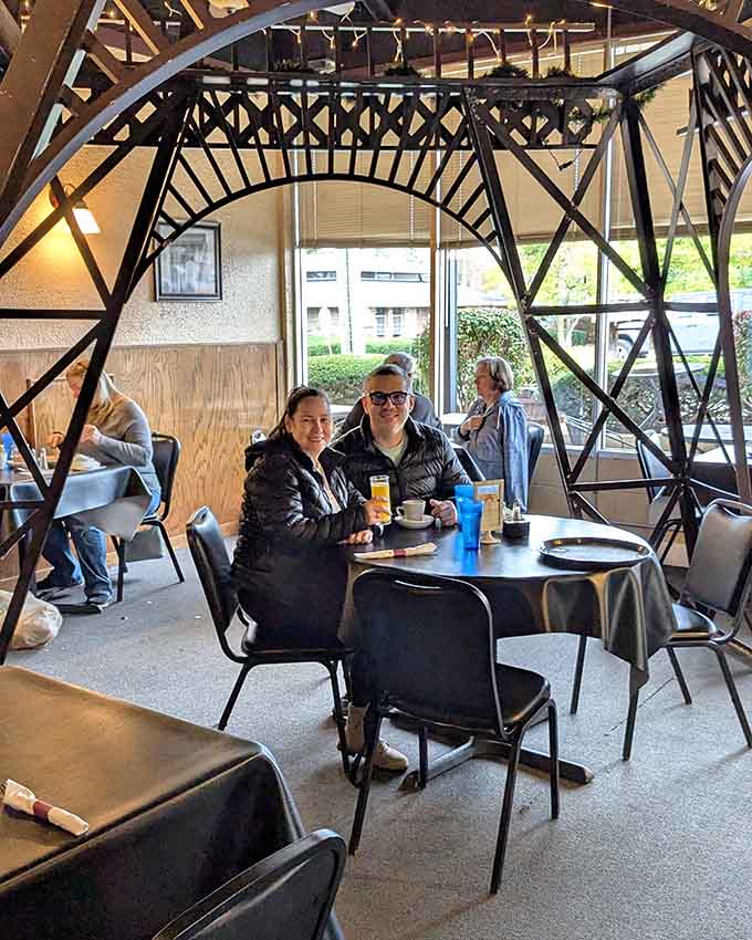 Happy diners enjoying their meal under the Eiffel Tower replica, living their best Parisian caf&eacute; life in suburban Illinois.