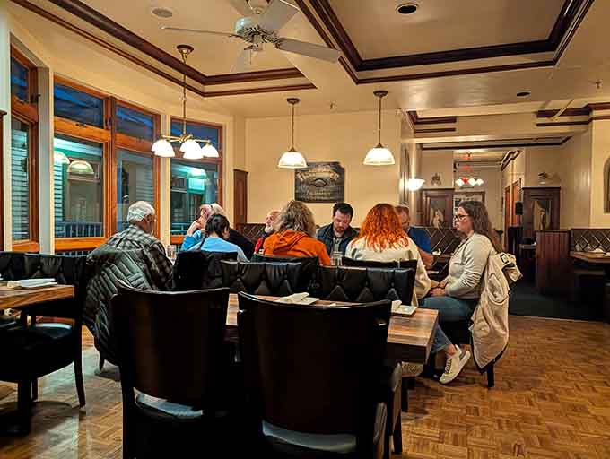 Happy diners gathered around a table, probably discussing how they're going to fit dessert in after those tacos.