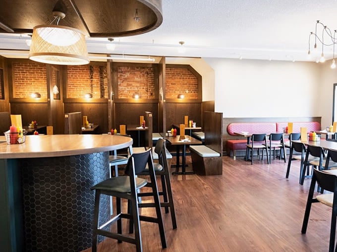 Exposed brick and thoughtful lighting create an atmosphere that's both contemporary and warmly inviting throughout the space.