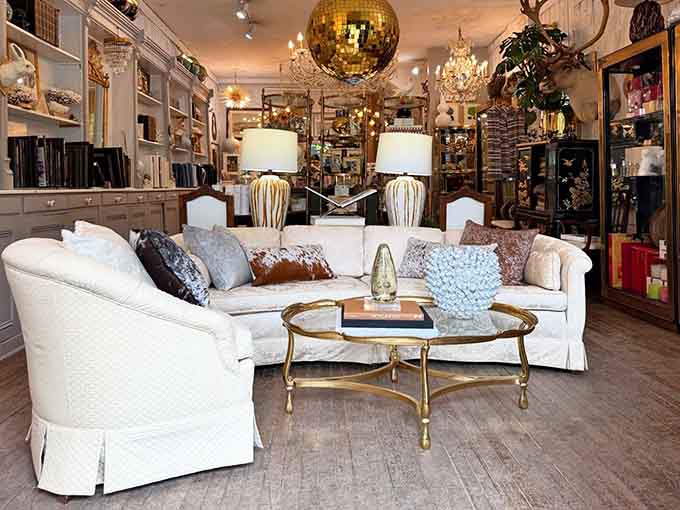 White slipcovered sofas anchor a space where every surface tells a story and every corner offers another reason to pull out your credit card.