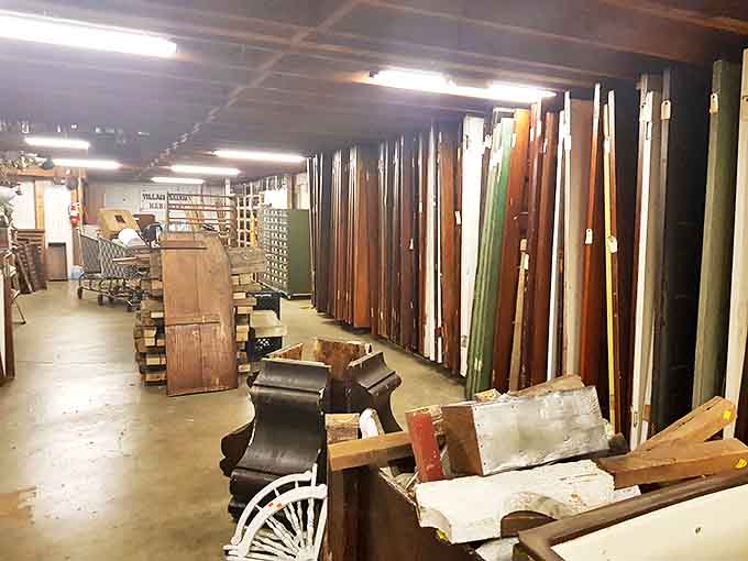 Village Salvage's basement reveals architectural treasures awaiting new life &ndash; a forest of salvaged doors standing like soldiers at attention.