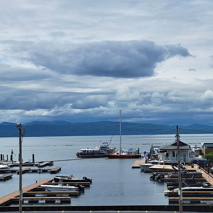 Lake Champlain stretches toward distant mountains, creating a backdrop that makes everything taste just a little bit better.