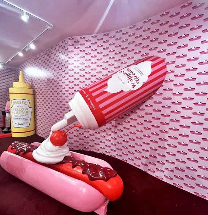 Pop art meets dessert fantasy in this oversized whipped cream hot dog sculpture that makes a playful statement about food culture.