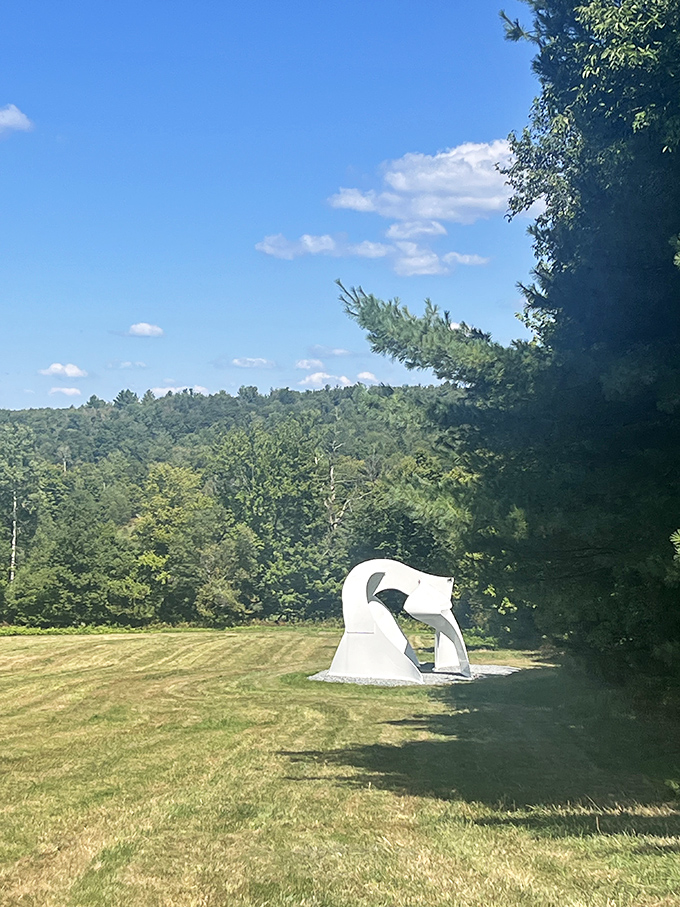 The white sculpture stands in elegant contrast to Vermont's lush greenery, like a graceful dancer frozen mid-performance.
