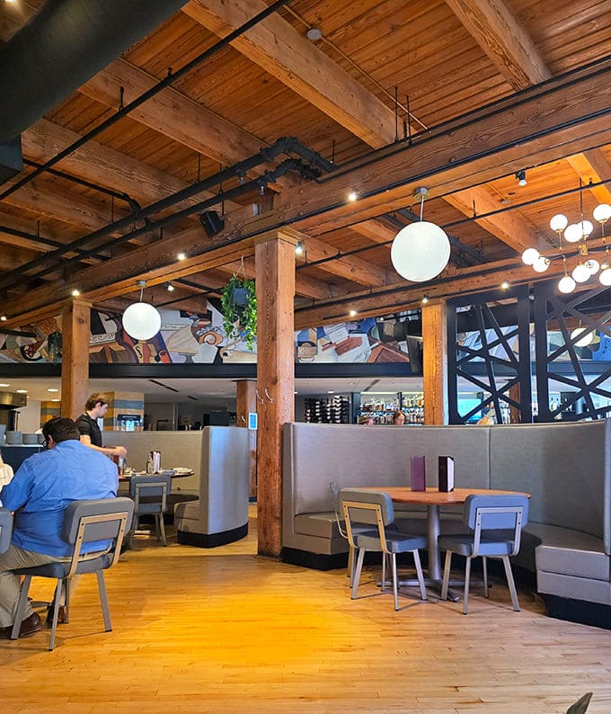 Wooden beams and globe lights create an atmosphere that makes everyone look like they're starring in their own romantic comedy.