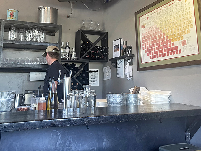 The bar area combines functionality with style, offering a front-row seat to the pizza-making action while you enjoy a pre-dinner drink.