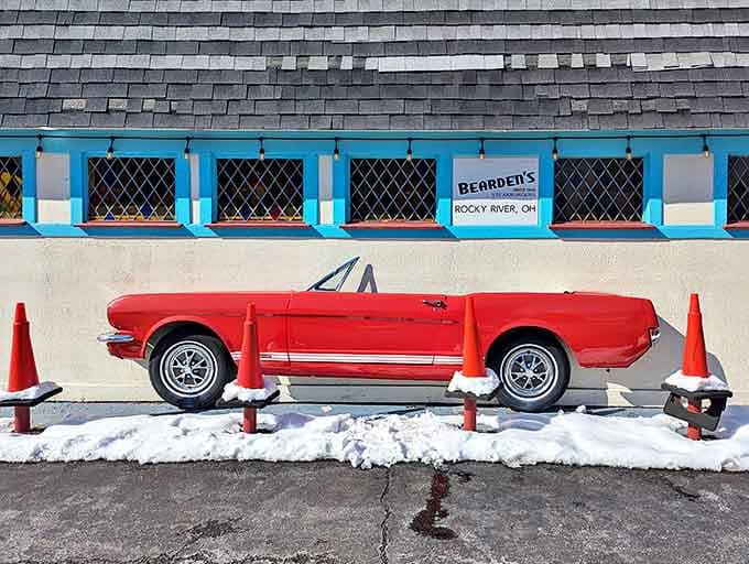 Even in winter, the classic Mustang stands guard outside, a fiery red sentinel promising good times and great food within these hallowed walls.