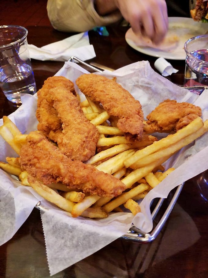 Crispy chicken tenders and golden fries arrive in an unpretentious basket &ndash; comfort food that doesn't need fancy plating to impress.