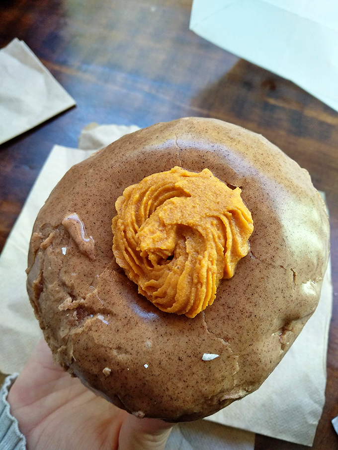 That cocoa glaze with pumpkin buttercream looks like fall decided to become a donut, and honestly, that's the best decision fall has ever made besides sweater weather.
