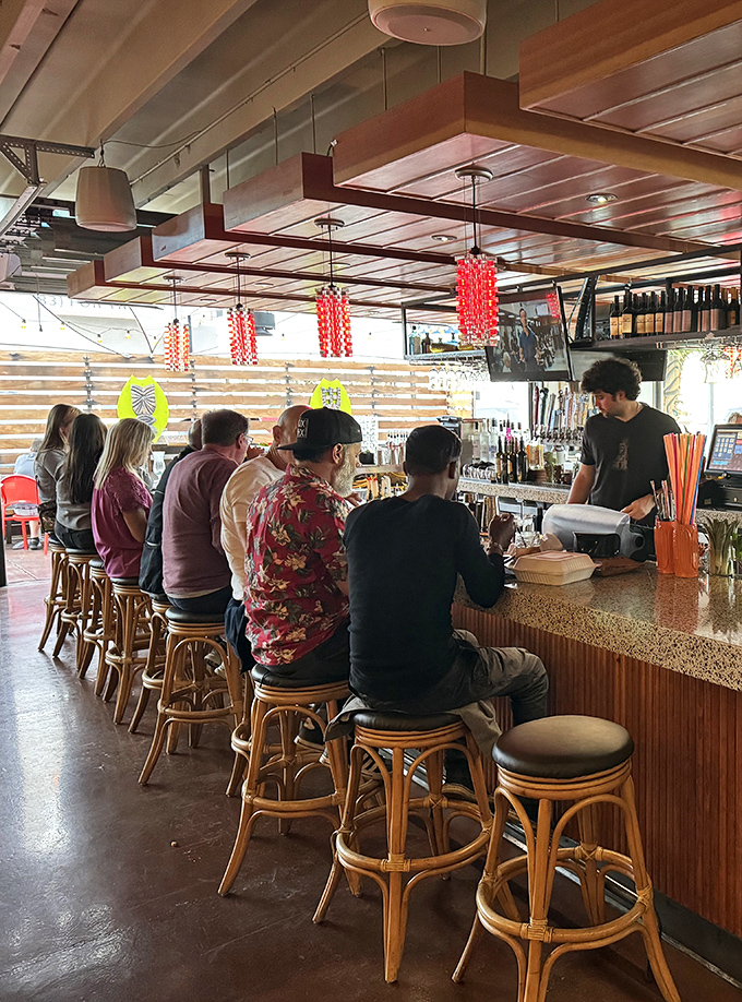 The bar draws a diverse crowd of tiki enthusiasts and curious newcomers, all united in their quest for a taste of the tropics.