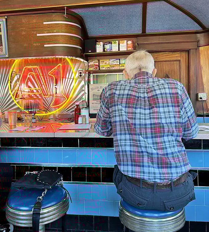 A patron enjoying the ritual of counter dining, where regulars become family and first-timers are welcomed like old friends.