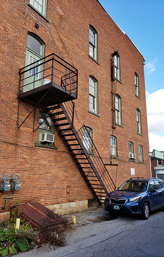 The building's historic fire escape adds character to the brick exterior, a reminder of practical craftsmanship from a bygone era.
