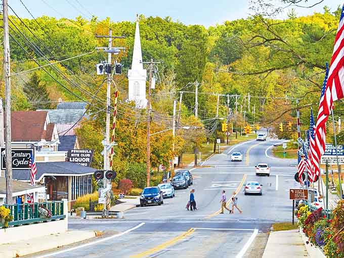 American flags flutter along Peninsula's main street, where every building tells a story of small-town resilience.