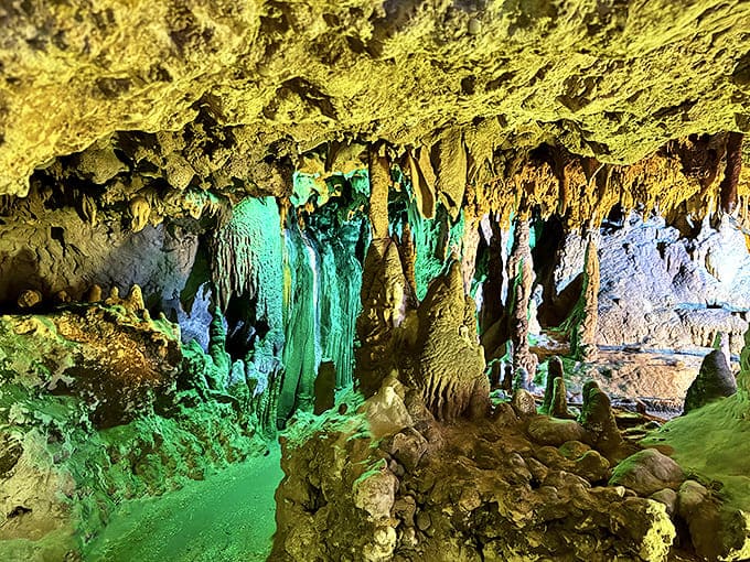 Emerald and turquoise lighting transforms this limestone chamber into an underwater fantasy, despite being completely dry and walkable.