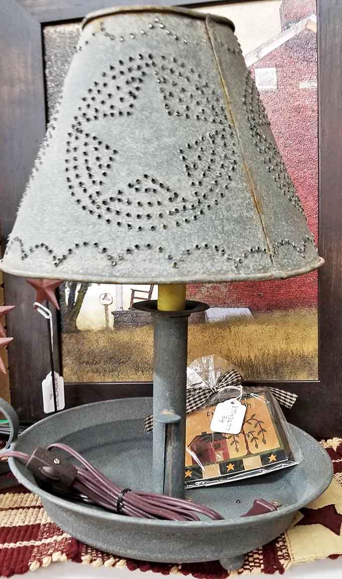 A primitive star-punched tin lampshade transforms ordinary light into magical patterns, craftsmanship from a simpler era.