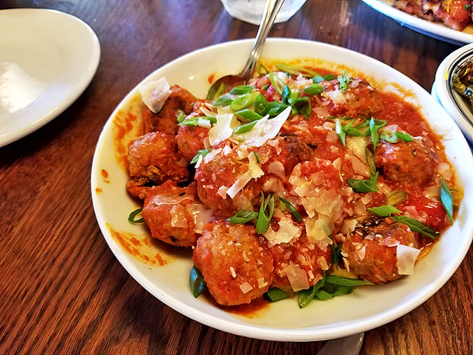 These tender meatballs are smothered in savory red sauce and topped with fresh herbs and cheese for a perfect start.