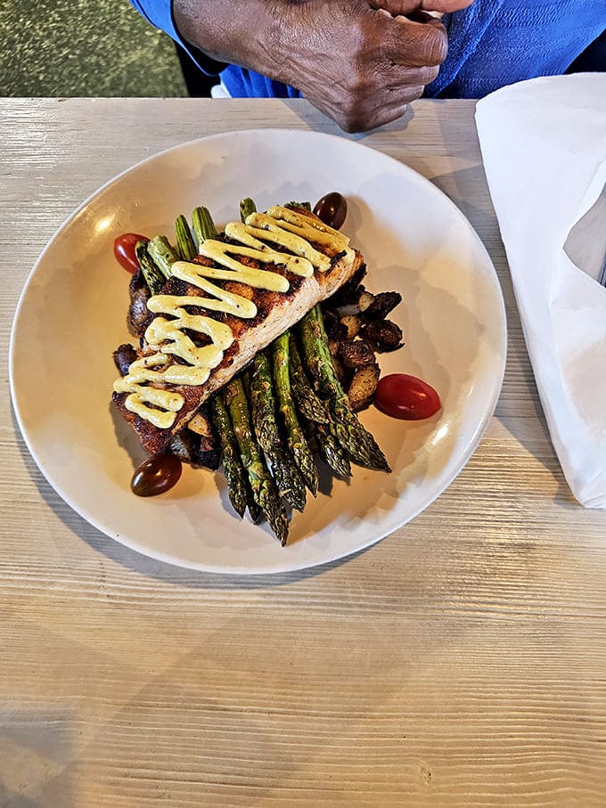 Perfectly seared fish perched atop asparagus spears &ndash; evidence that Mason Jar Cafe's culinary magic extends well beyond breakfast hours.