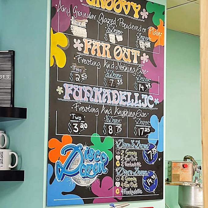 The "Disco Dozen" pricing board features psychedelic flowers and groovy lettering, channeling 1960s vibes with thoroughly modern flavors.