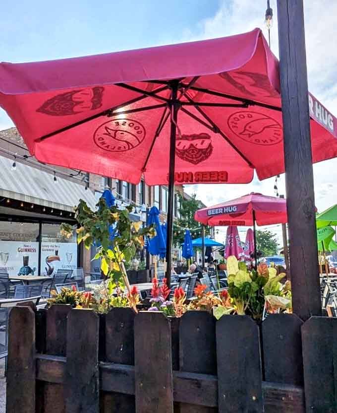 The outdoor patio features colorful umbrellas and lush planters, creating a vibrant urban oasis perfect for people-watching while enjoying those famous steak tacos.