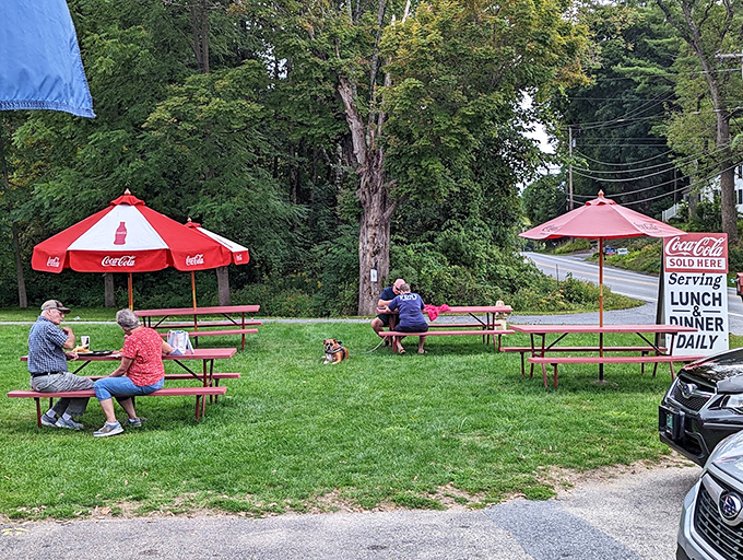 Red Coca-Cola umbrellas shade happy diners enjoying their treasures at picnic tables &ndash; Vermont's version of five-star ambiance.