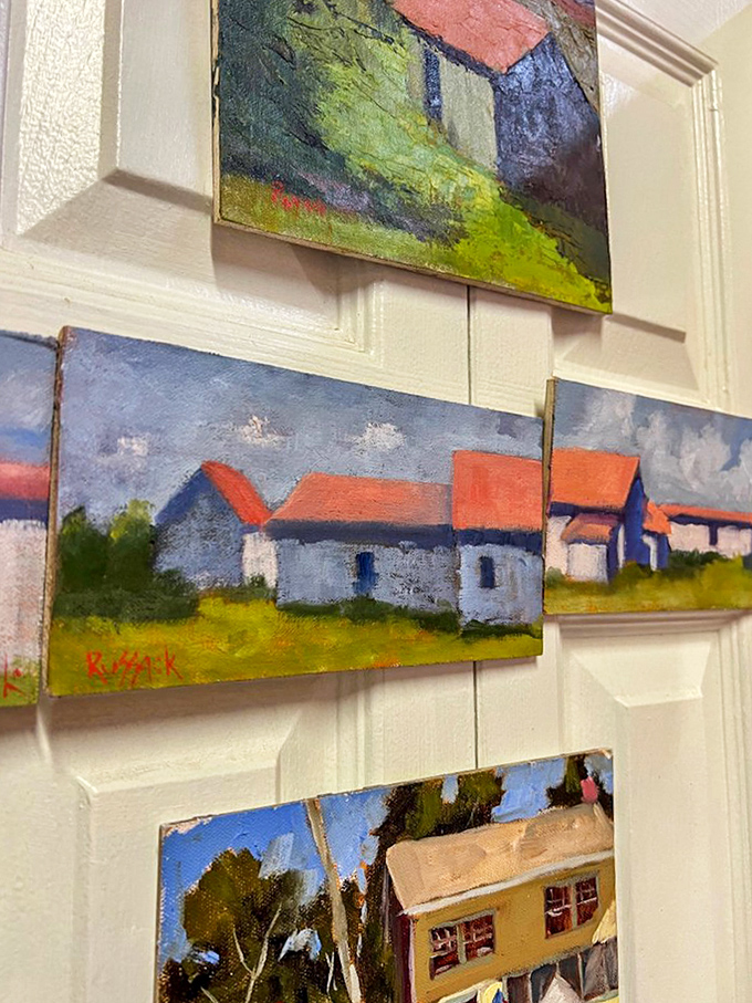 Small paintings capture rural scenes with vibrant colors, offering affordable art that brings character and history to blank walls.