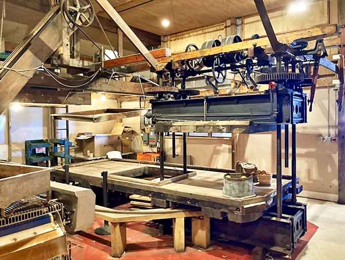 Behind the scenes in the processing facility, where antique equipment transforms ordinary apples into extraordinary cider through time-honored methods.