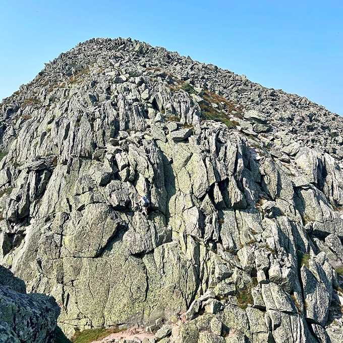 Granite giants stand defiant against time, challenging climbers to navigate their ancient faces with respect and steady footing.