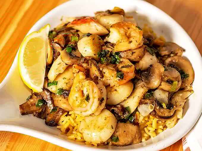 Seafood saut&eacute;: Plump shrimp and scallops mingle with mushrooms atop golden rice &ndash; simple ingredients transformed into something magical.