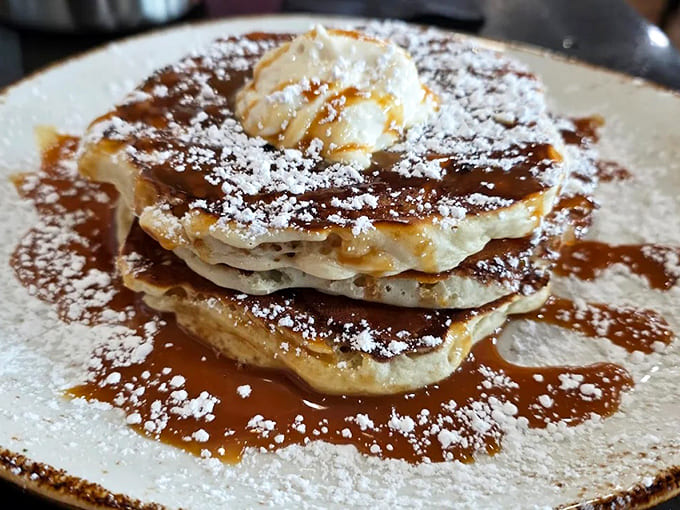 Pancake perfection &ndash; golden stacks drizzled with syrup and dusted with powdered sugar, ready to transport you back to childhood breakfast bliss.