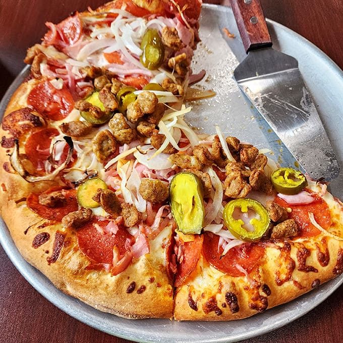 This thick-crust masterpiece stands as a monument to the belief that more is indeed more when it comes to pizza perfection.