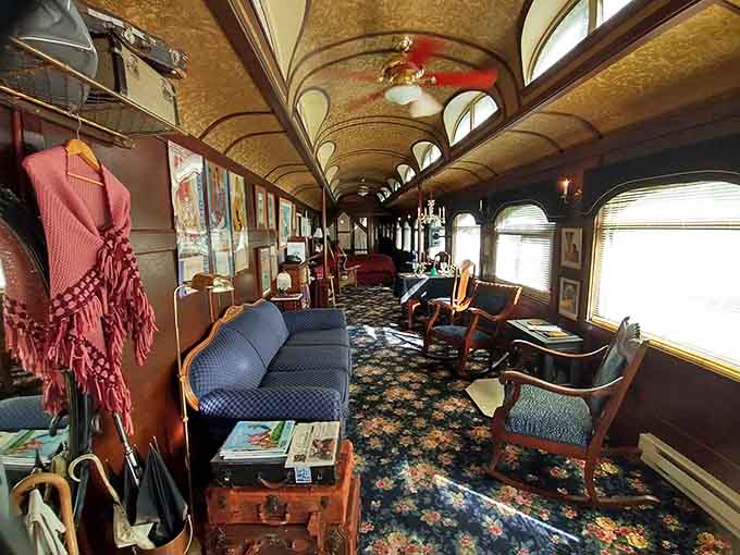 Rich wood paneling and vintage furnishings transform this railroad car into a rolling time capsule where comfort meets history.