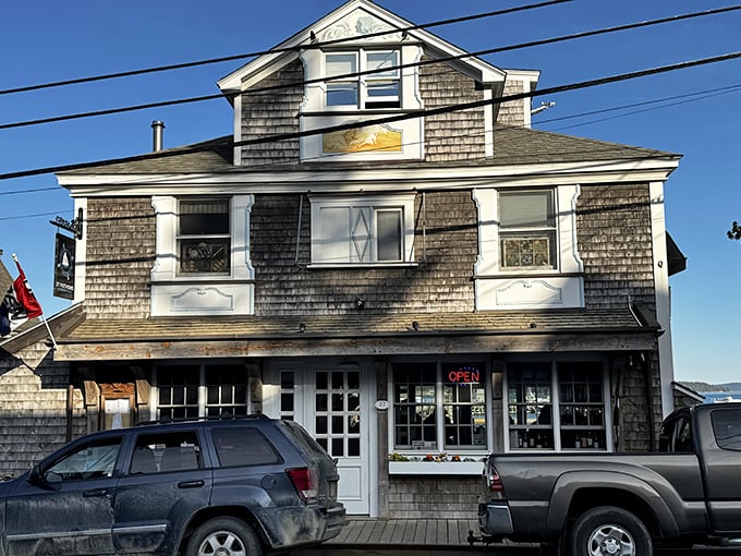 Weathered shingles and white trim frame this classic Stonington storefront, where local treasures await discovery by curious visitors.