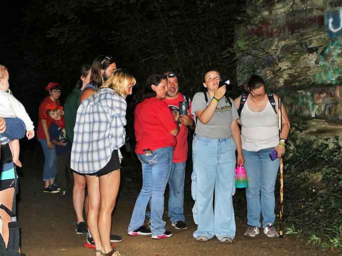 Ghost hunters gather with equipment ready, hoping to capture evidence of Moonville's legendary spectral residents.