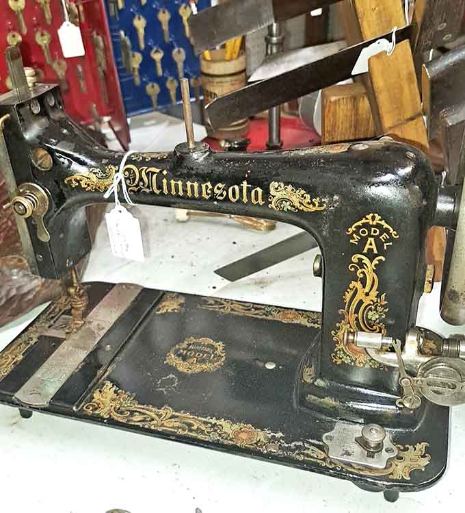 The ornate "Minnesota" sewing machine represents an era when household tools were built to last generations – functional art with its gold detailing.