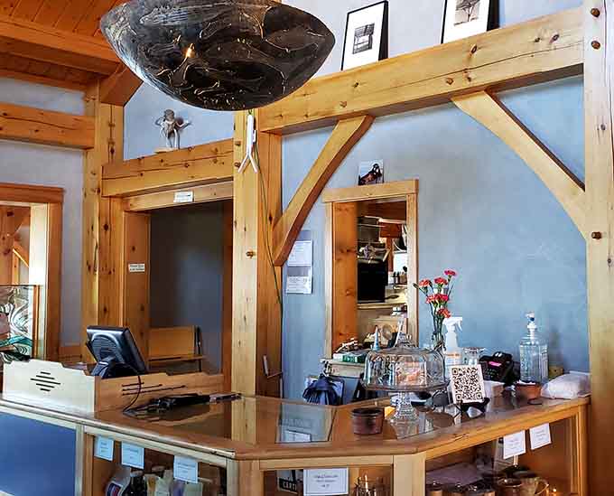 The curved bar and timber construction create a welcoming space where ordering feels less like a transaction and more like chatting with friends.