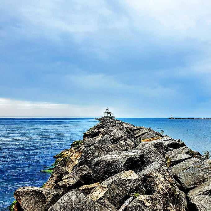 The lighthouse stands sentinel at the harbor entrance, a postcard-perfect reminder of Ashtabula's deep maritime heritage and Lake Erie's power.