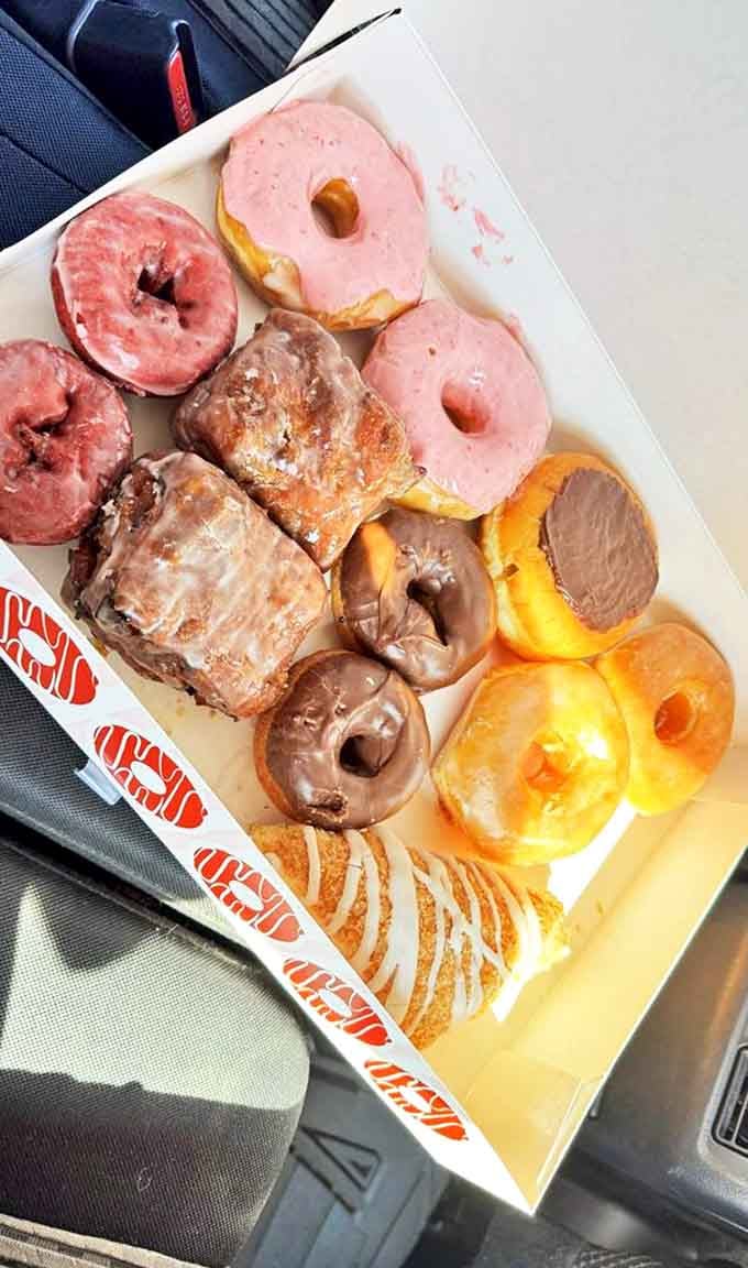 A box of donuts so beautiful it deserves its own museum exhibit titled "Why Humans Will Never Truly Embrace Kale."