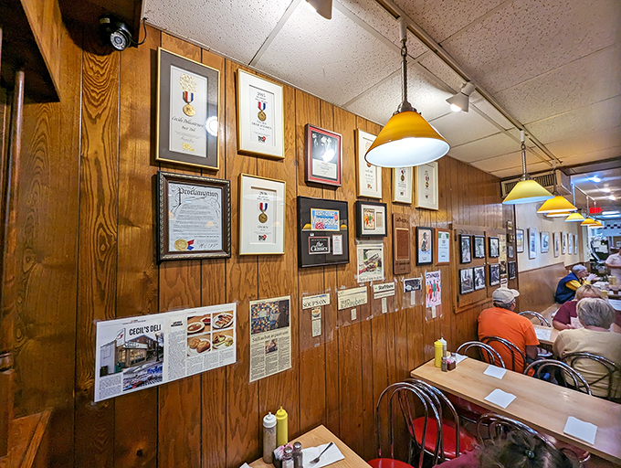 Cecil's Deli wall, full of awards and memorabilia, sharing history with happy diners.