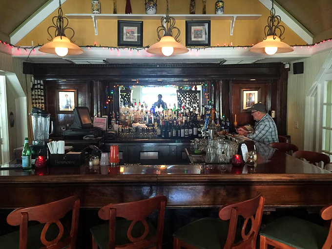 The bar area glows with amber warmth, bottles standing at attention like soldiers ready to enhance your evening.