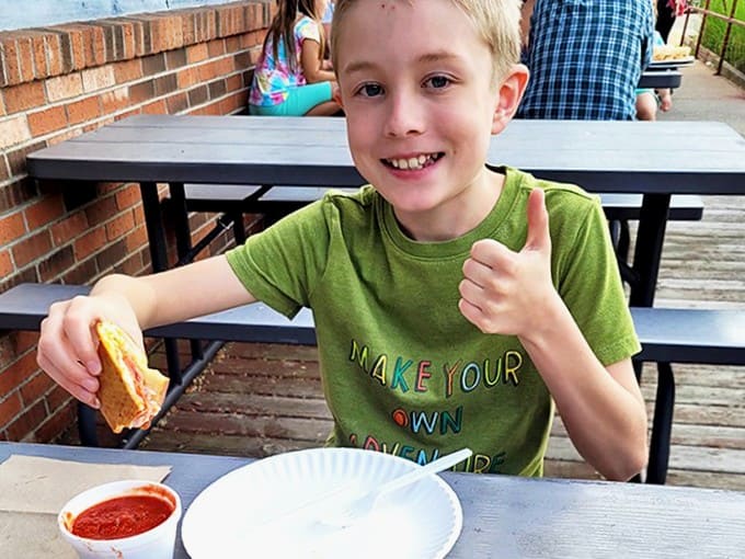 The outdoor dining area offers a perfect spot to enjoy your meal while watching Manistee life unfold &ndash; simple pleasures at their finest.