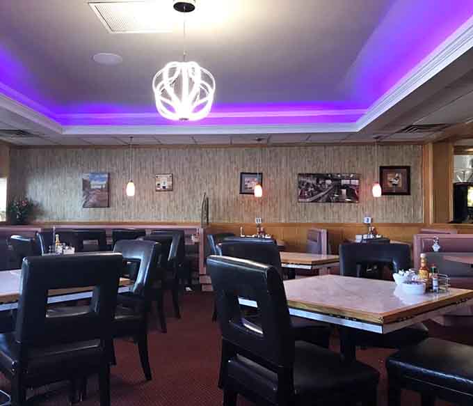 The dining room's purple accent lighting adds unexpected flair to this otherwise classic cafe space.