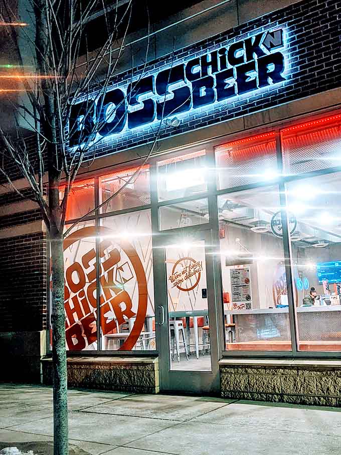 The electric-blue Boss Chick N Beer sign illuminates the night, a beacon for hungry travelers seeking crispy, saucy satisfaction in Berea.