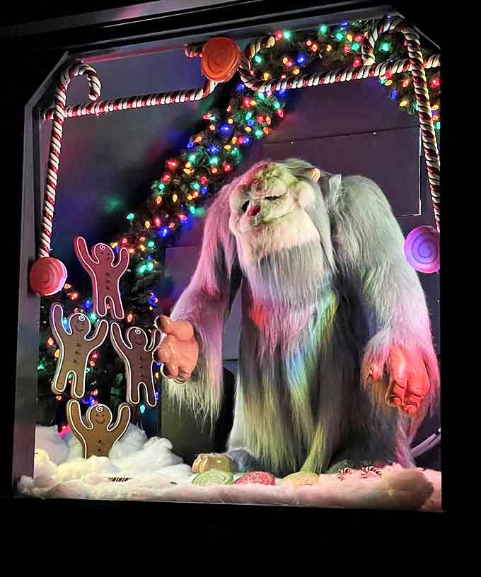 The legendary Abominable Snowman offers a surprisingly gentle greeting, his fearsome reputation softened by twinkling lights and gingerbread friends.