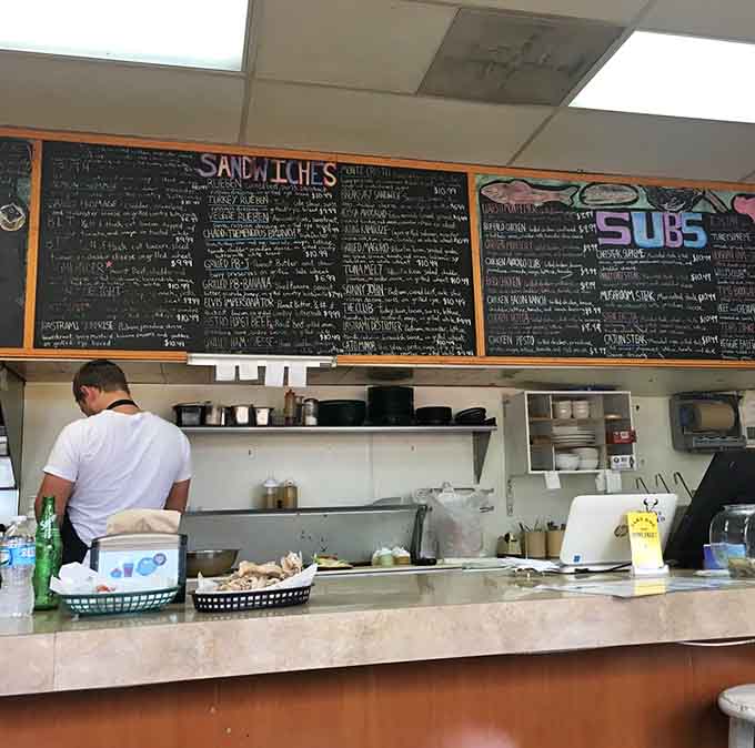 Behind the counter, culinary magic happens with practiced precision &ndash; these aren't just cooks, they're comfort food engineers at work.