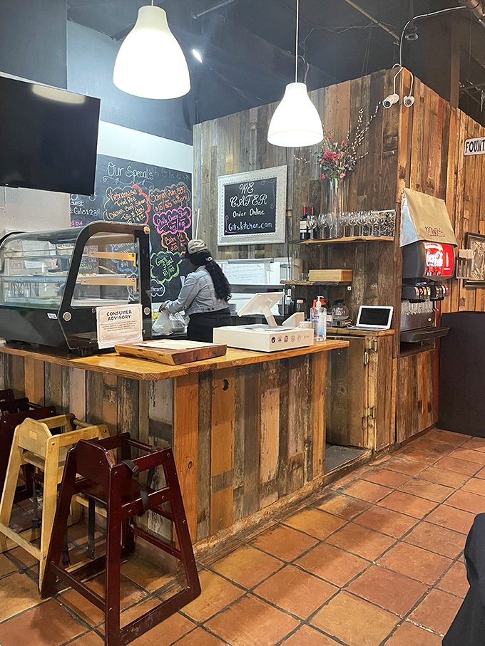 Rustic wooden paneling and chalkboard menus create an unpretentious welcome, while the open kitchen layout invites diners into the culinary conversation.