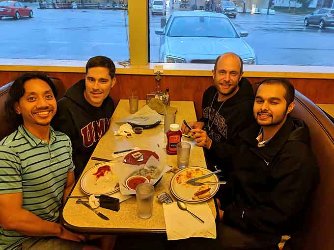 Friends gathering over plates of comfort food, creating memories one delicious bite at a time in this welcoming community gathering spot.
