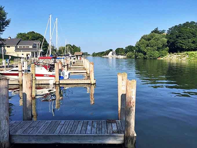 Wooden docks stretch into the calm waters, creating perfect launching points for adventures on Manistee's historic river highway.