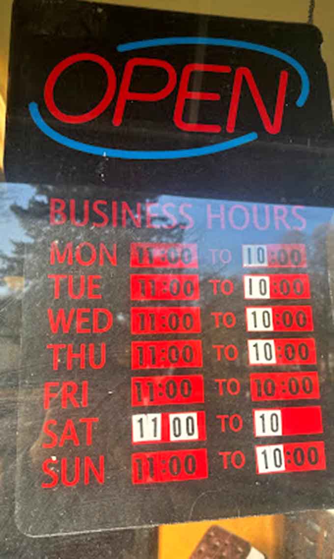 Business hours posted clearly so you know exactly when to satisfy those pizza cravings throughout the week.