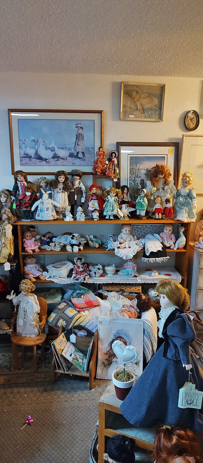 Porcelain dolls with stories to tell line these shelves, their expressions unchanged by decades of witnessing the world transform around them. 